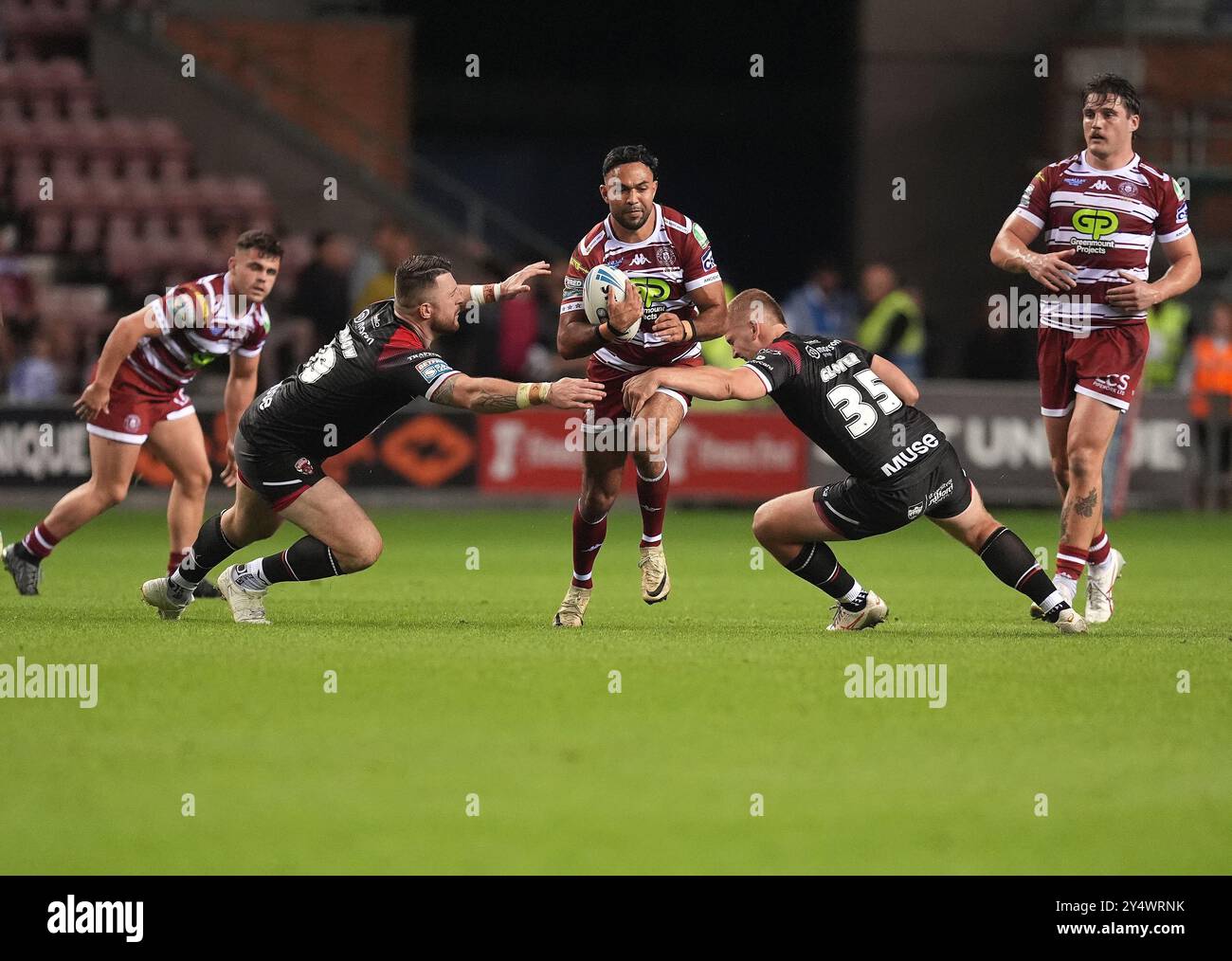 Wigan Warriors’ Bevan French breaks the tackle of Salford Red Devils ...