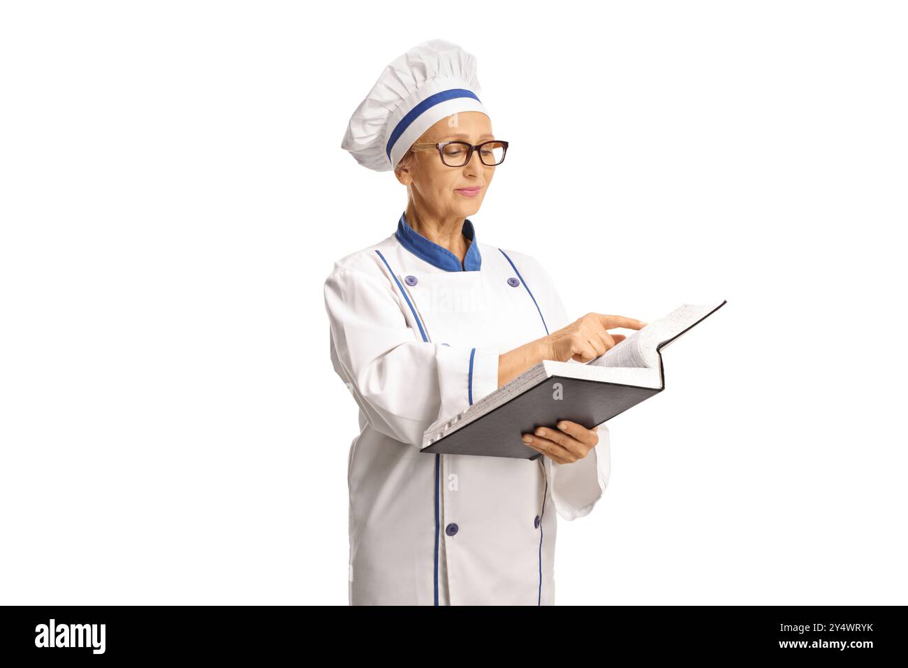 Female chef reading a recipe in a cook book isolated on white ...