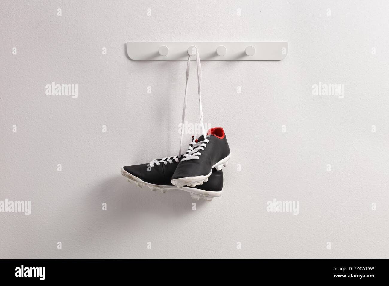 Pair of football cleats hanging on a wall Stock Photo - Alamy