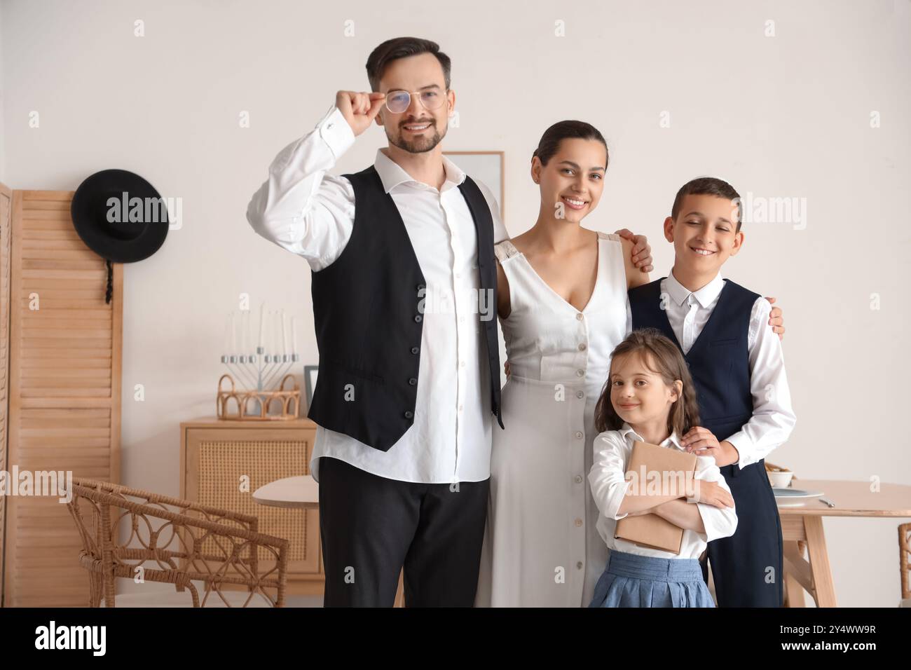 Happy Jewish family with book at home Stock Photo - Alamy
