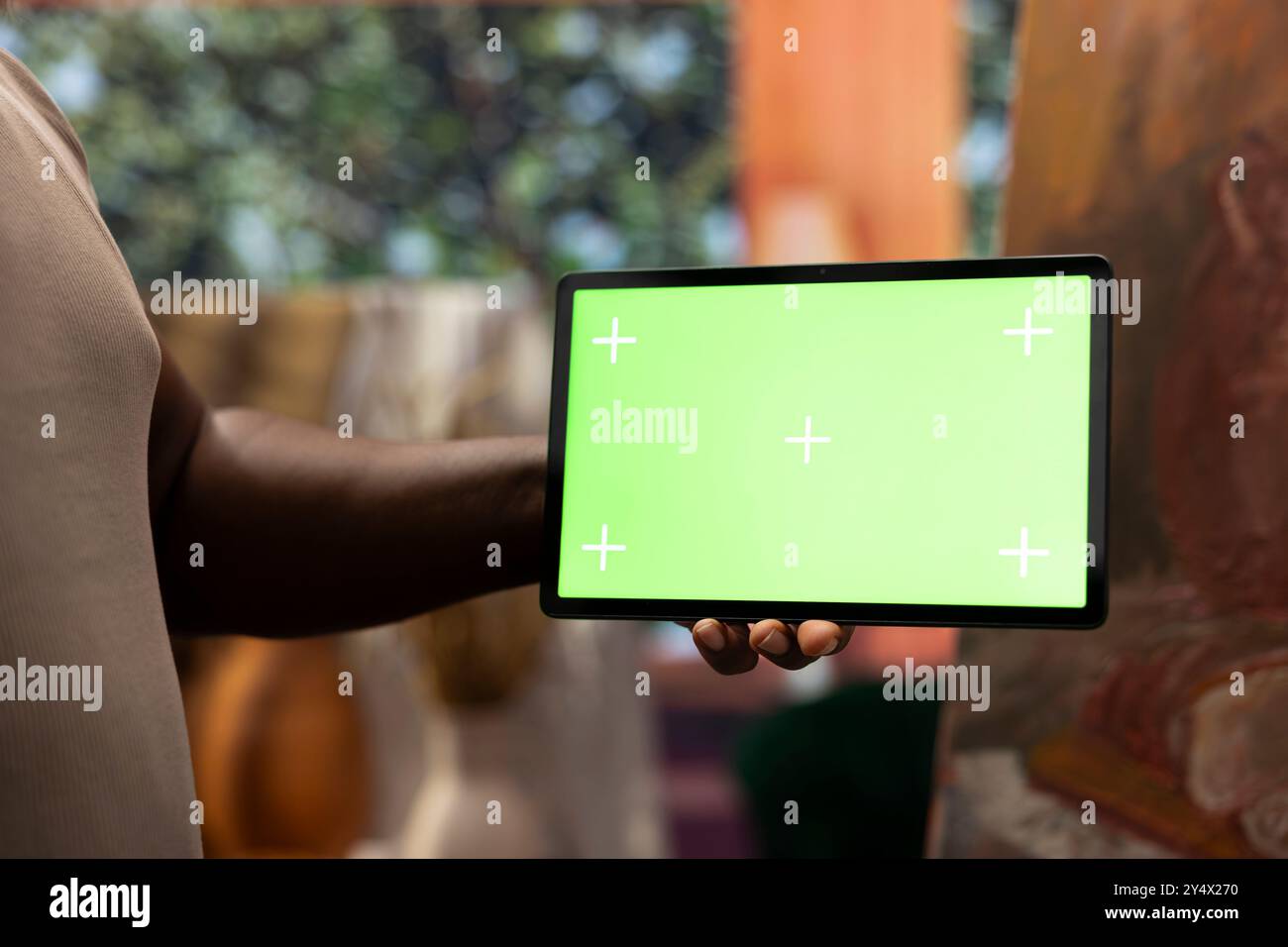 African american artist holding device with green screen mockup in art ...