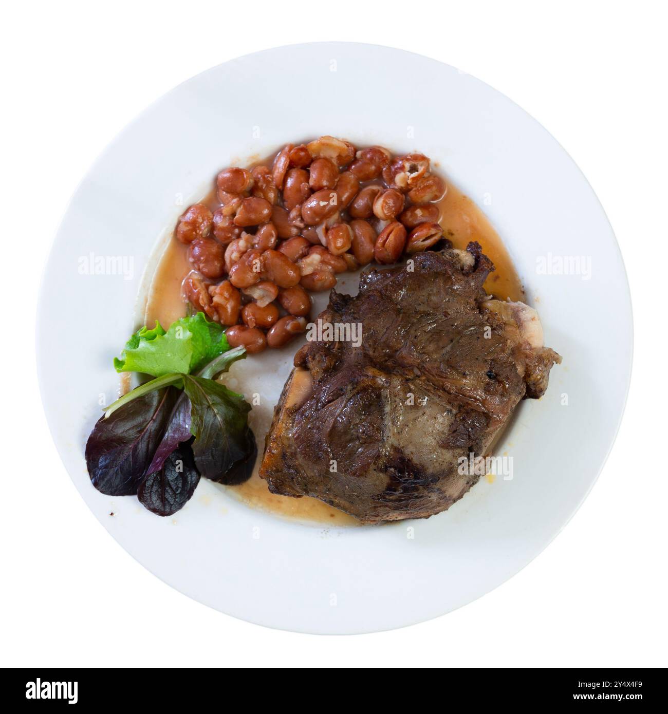Pork cheeks served with beans on plate Stock Photo - Alamy