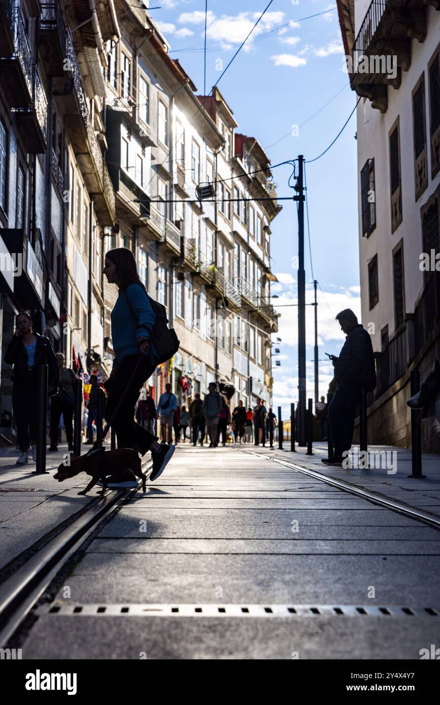 People make their way through Porto, Portugal in the late afternoon ...