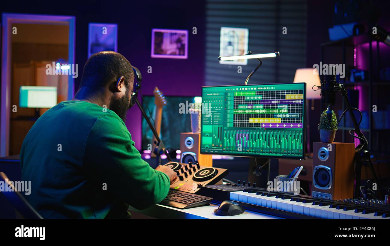 African american composer creating a new track for a project, using ...