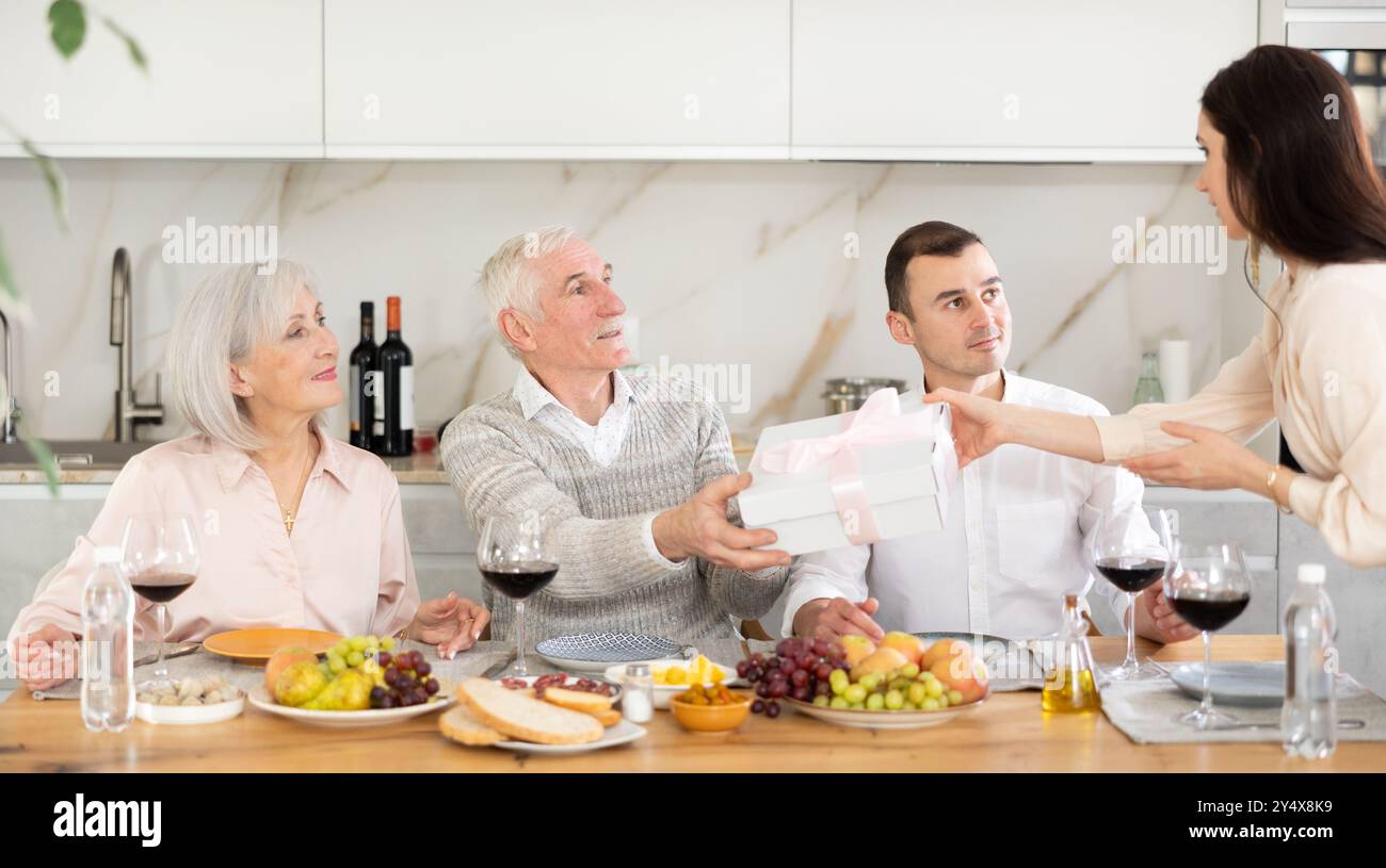 Birthday senior man accepts outright gift and greetings from adult ...