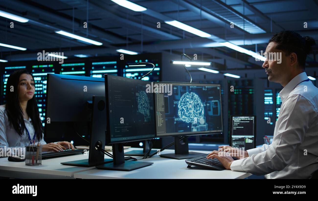 Computer scientist using AI tech on PC to do checkup in server room. IT staff member in data ...