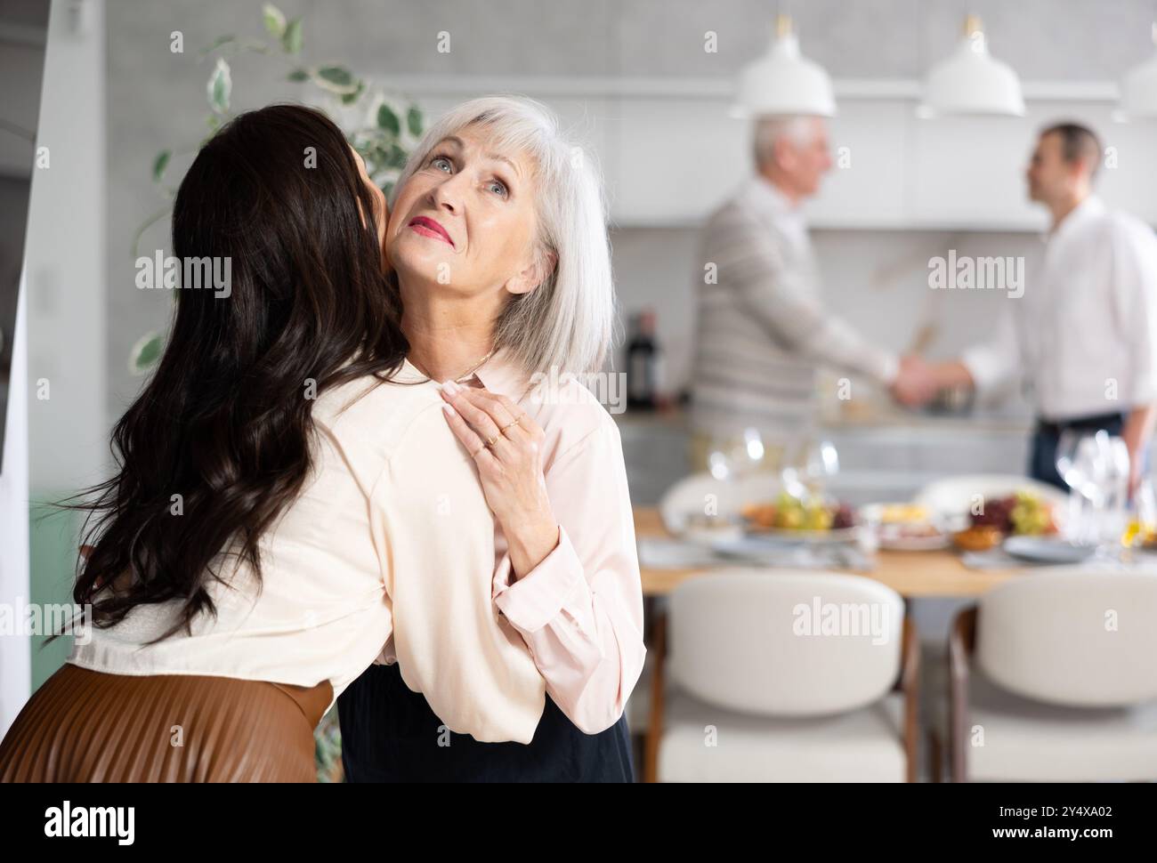 After chatting and gatherings, women friends hug and kiss goodbye Stock ...