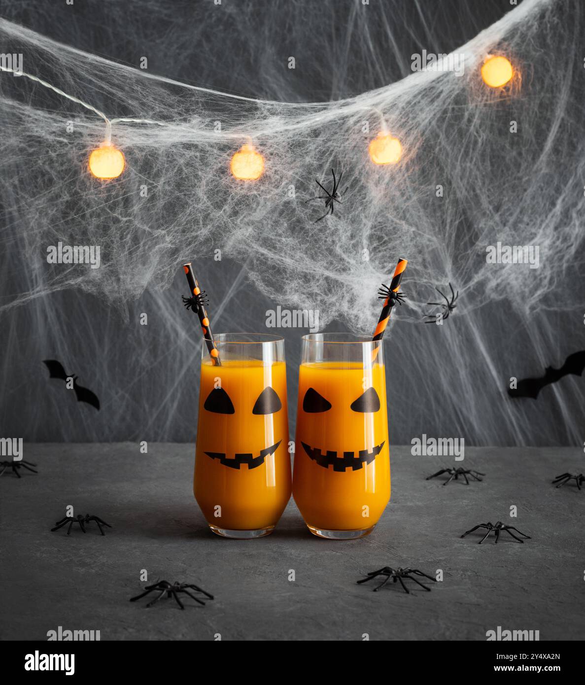 Halloween themed drinks with a cute creepy pumpkin design. Two glasses ...