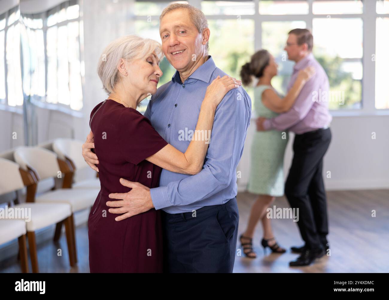 Elderly woman is dancing slow unhurried dance in hugs arms of her ...