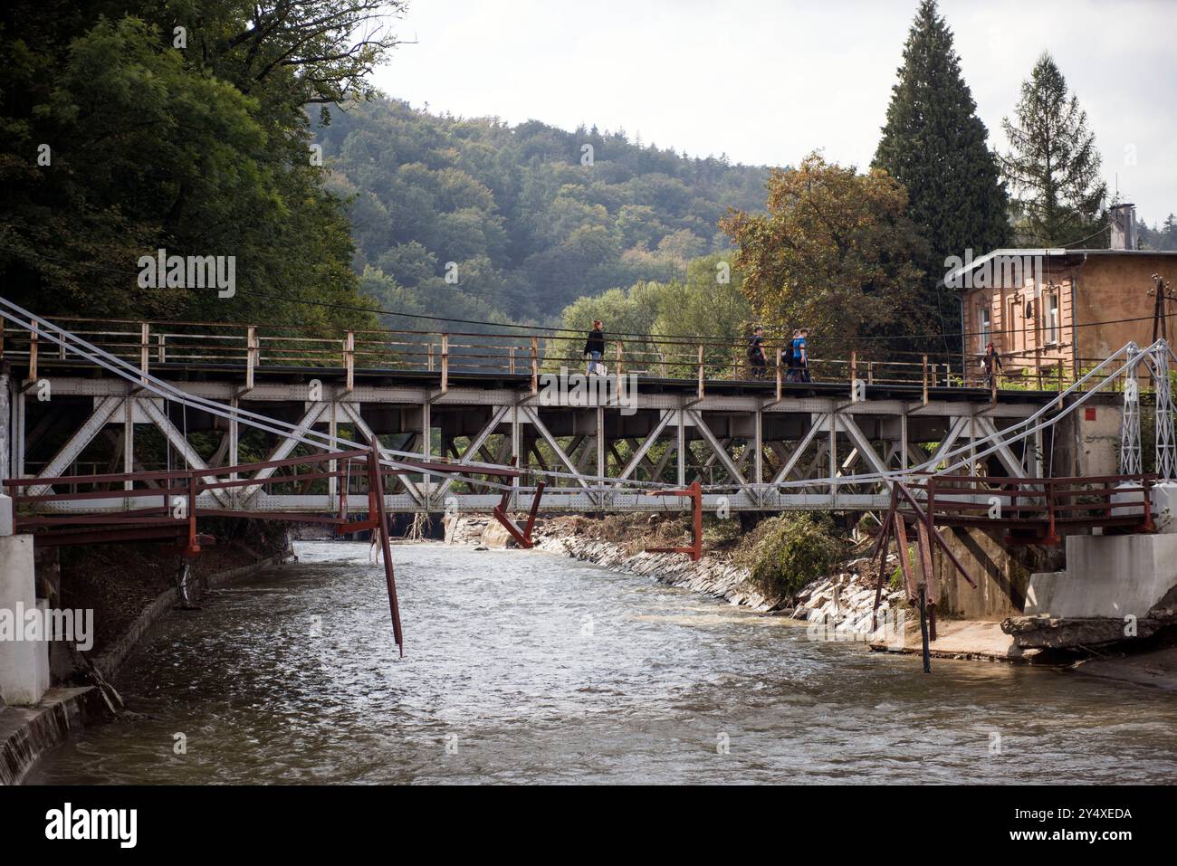 A view of a train bridge next to a footbridge destroyed due to flooding ...