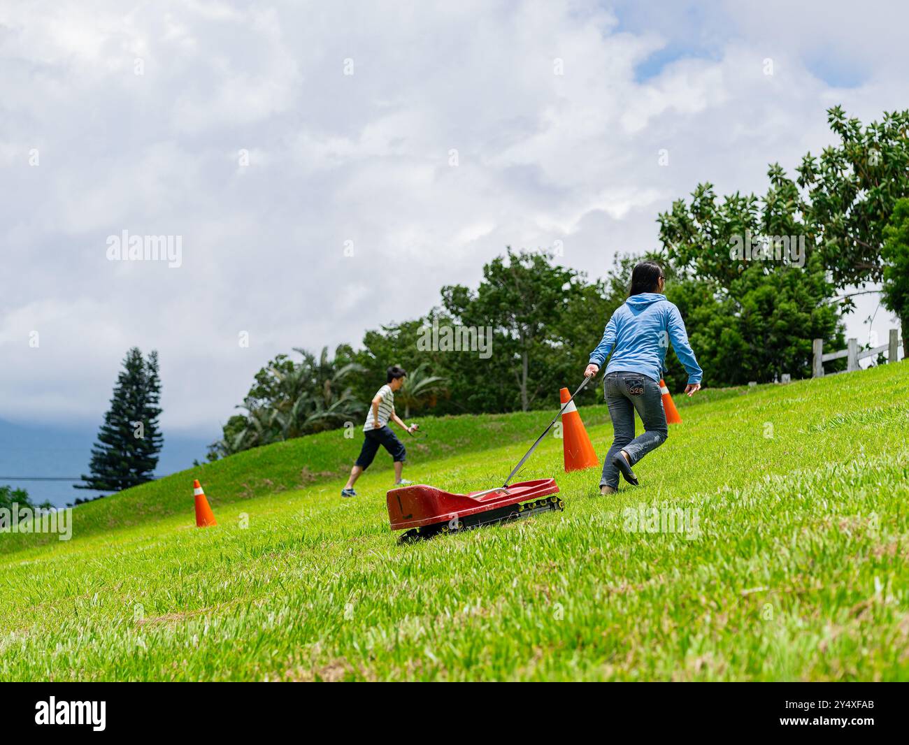 Close up shot of kids playing grass sledding at Taitung, Taiwan Stock ...
