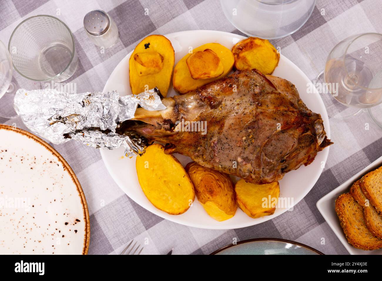 Traditional Spanish lunch is served - fried baked leg of lamb with side ...