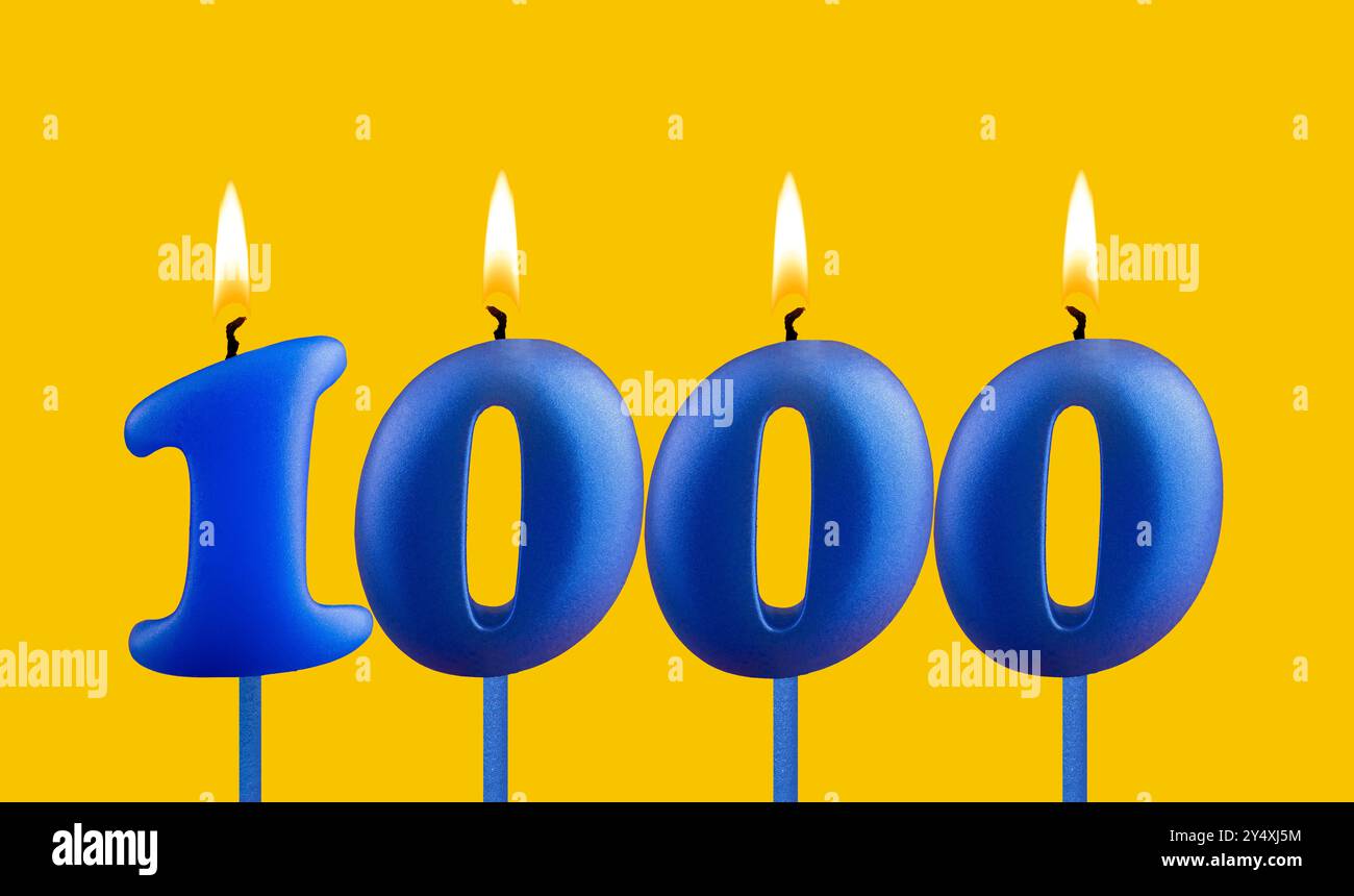 Blue birthday candle on yellow background - Number 1000 Stock Photo - Alamy