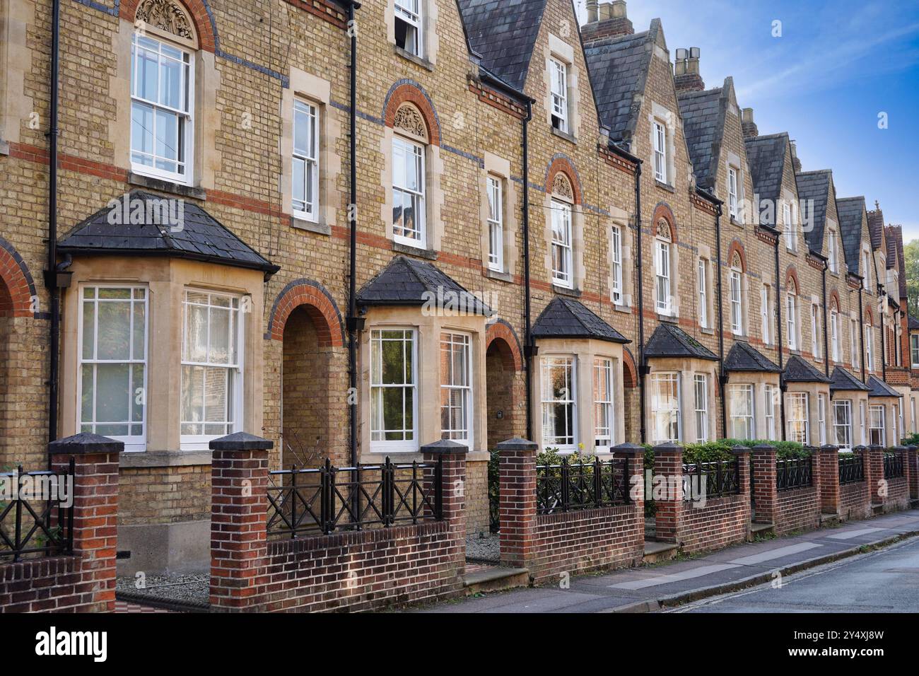 Row of modest brick English suburban homes with gables Stock Photo - Alamy