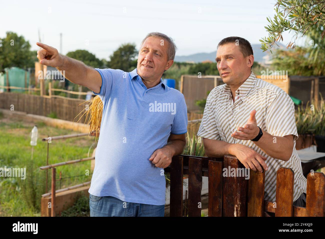 Two men neighbors standing hi-res stock photography and images - Alamy