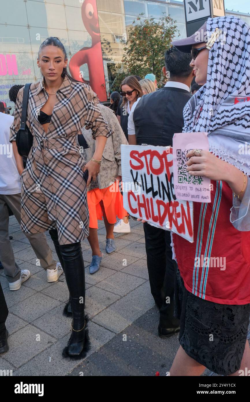 Model and activist Cora Corre passes a pro-Palestine protester as she ...