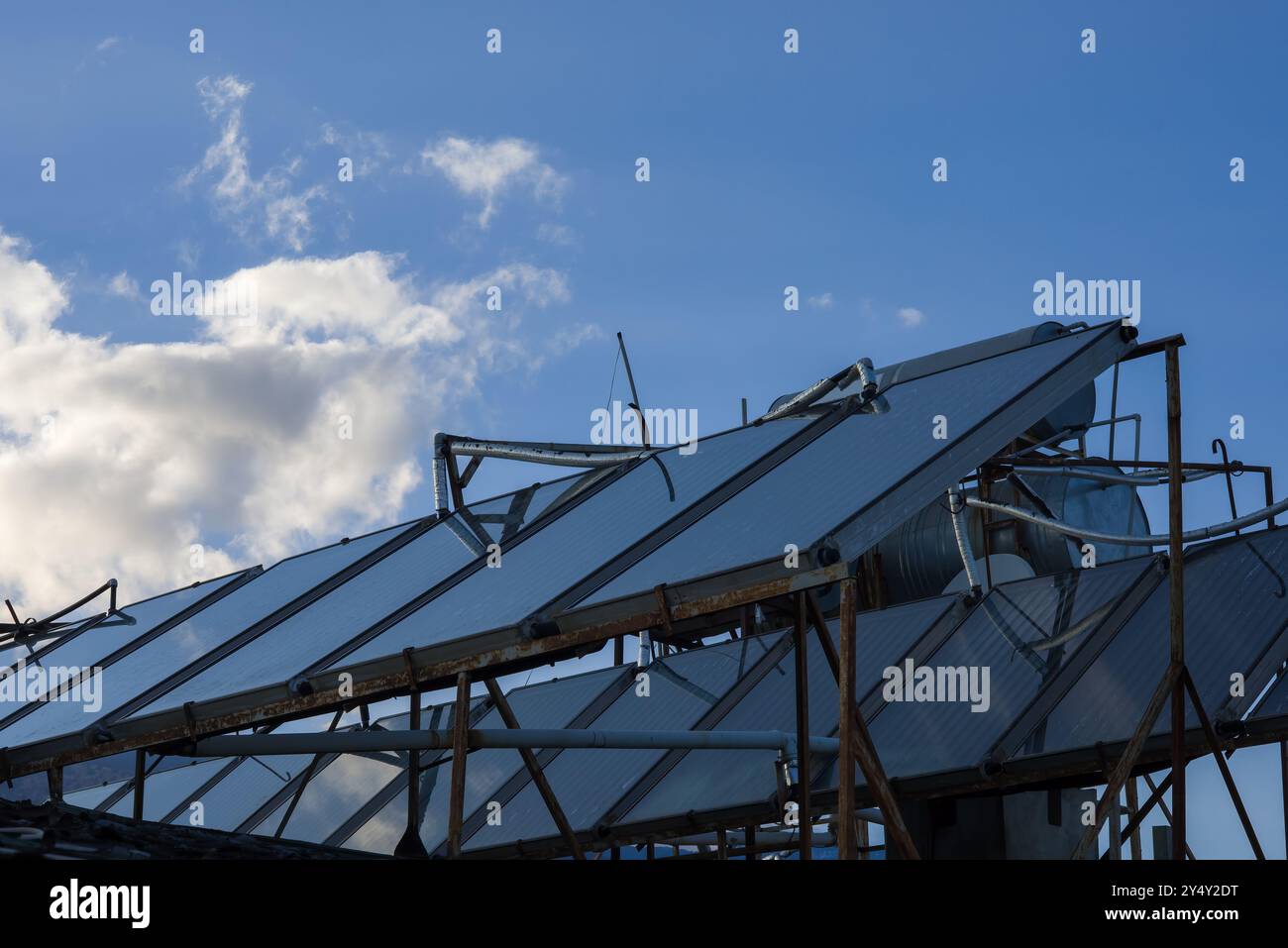A rooftop view of solar panels installed to capture sunlight, under a ...
