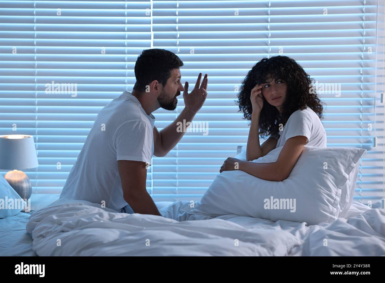 Emotional couple arguing in bedroom at night. Relationship problems ...