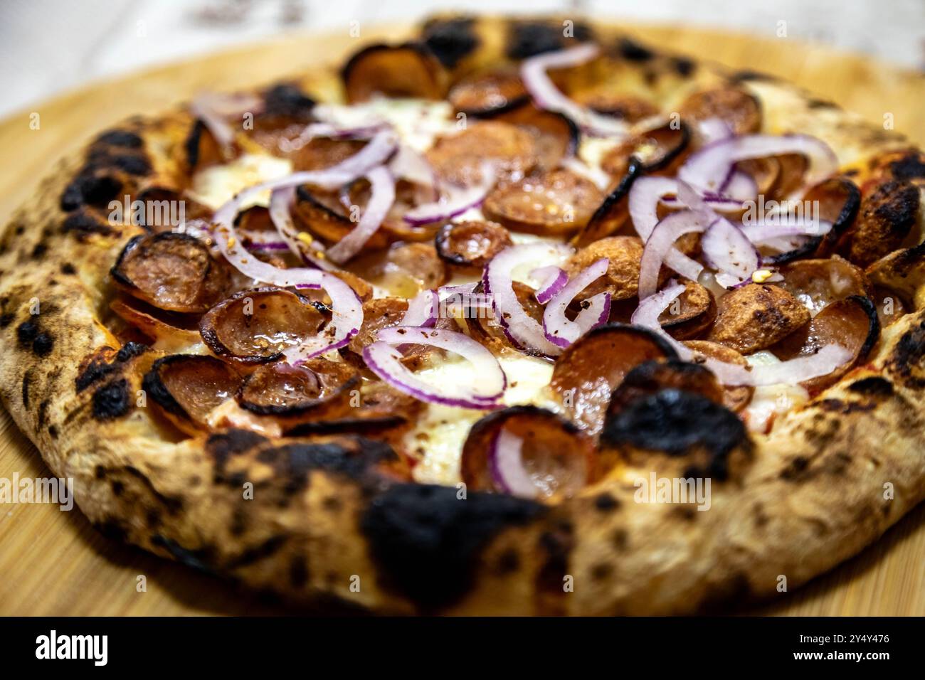 Rustic artisanal pepperoni pizza with red onion Stock Photo - Alamy