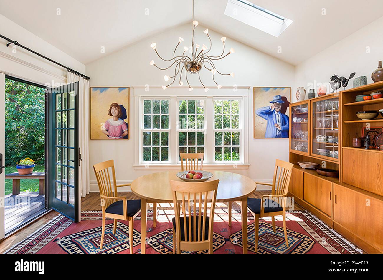 Light filled dining room with peaked ceiling and skylight Stock Photo ...