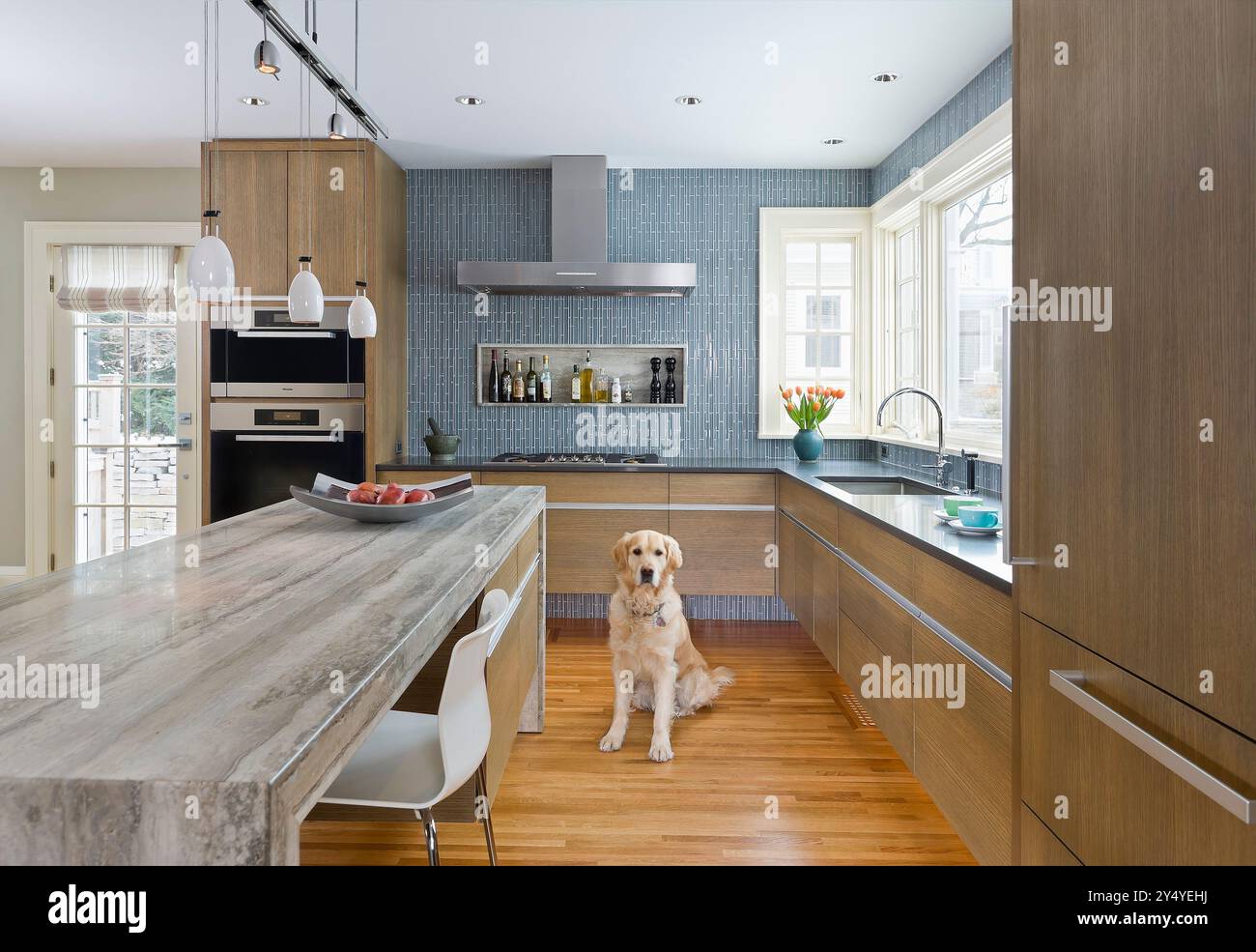 Modern kitchen with rift sawn oak cabinets and large stone island with ...