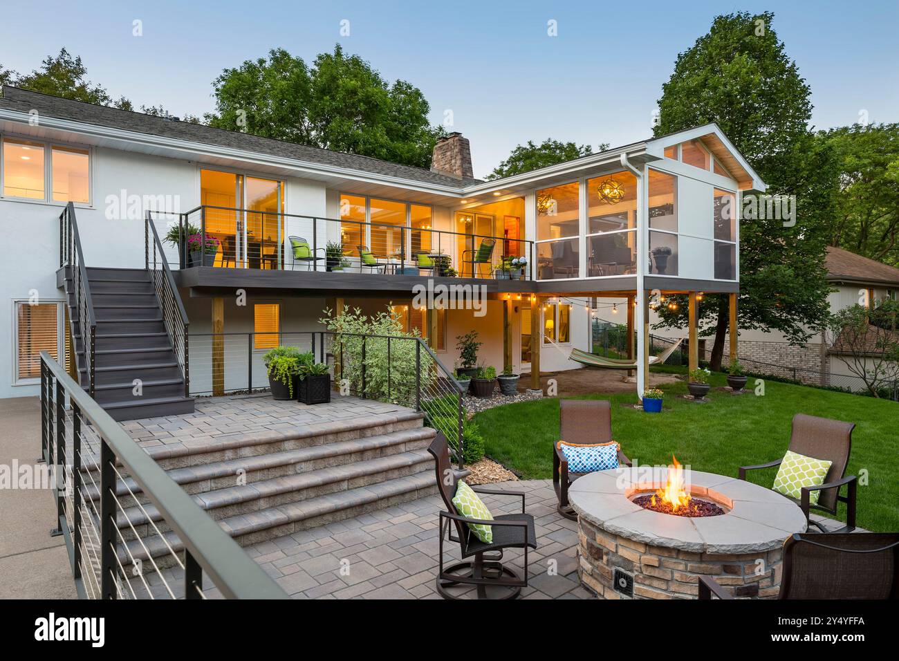 Back of split level house with new deck, patio and screened porch Stock Photo - Alamy