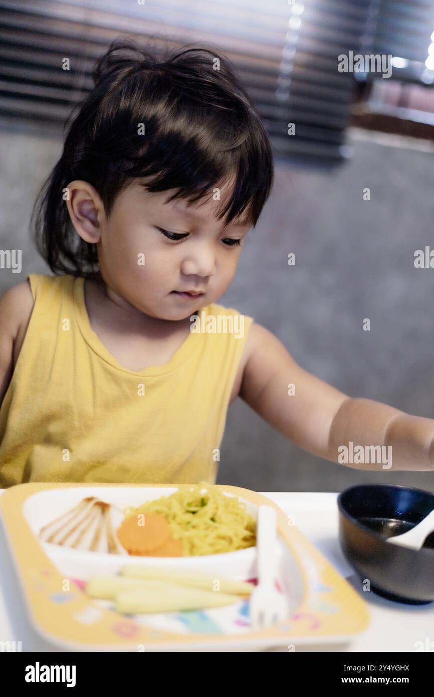 Little boy eating delicious Roasted pork Noodle by himself Stock Photo ...