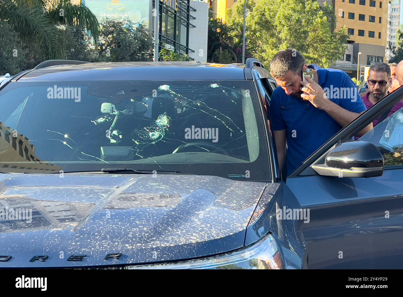 FILE - Police officers inspect a car inside of which a hand-held pager ...