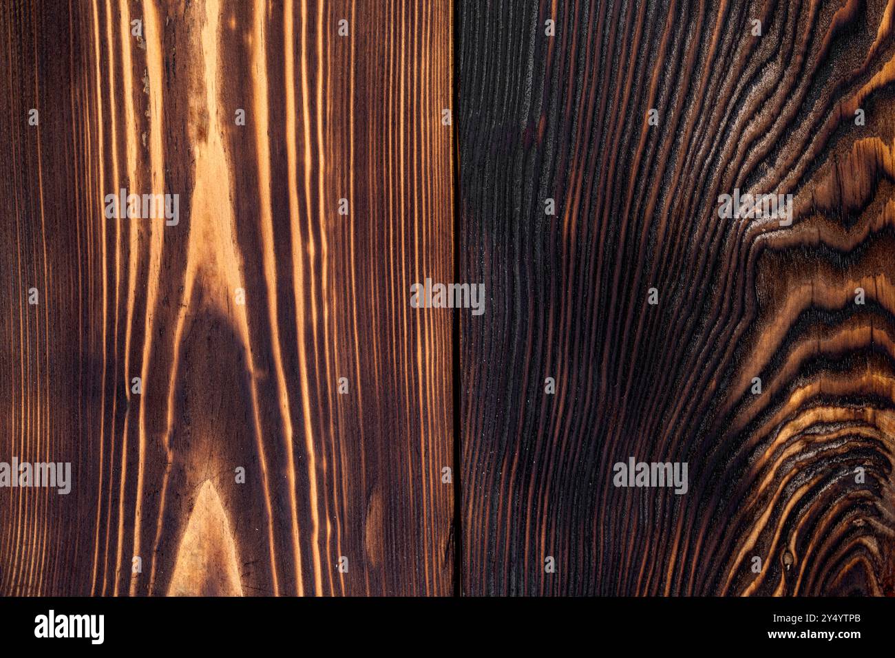 The wood grain is very visible and the wood is burnt. The burnt wood ...