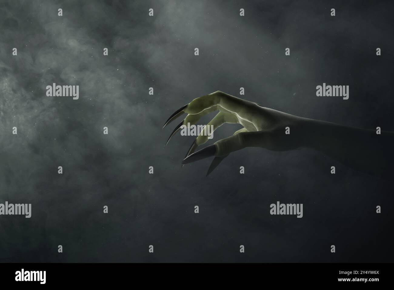 Witches hand with long nail claw. The color is green. Evil, zombie, or ...