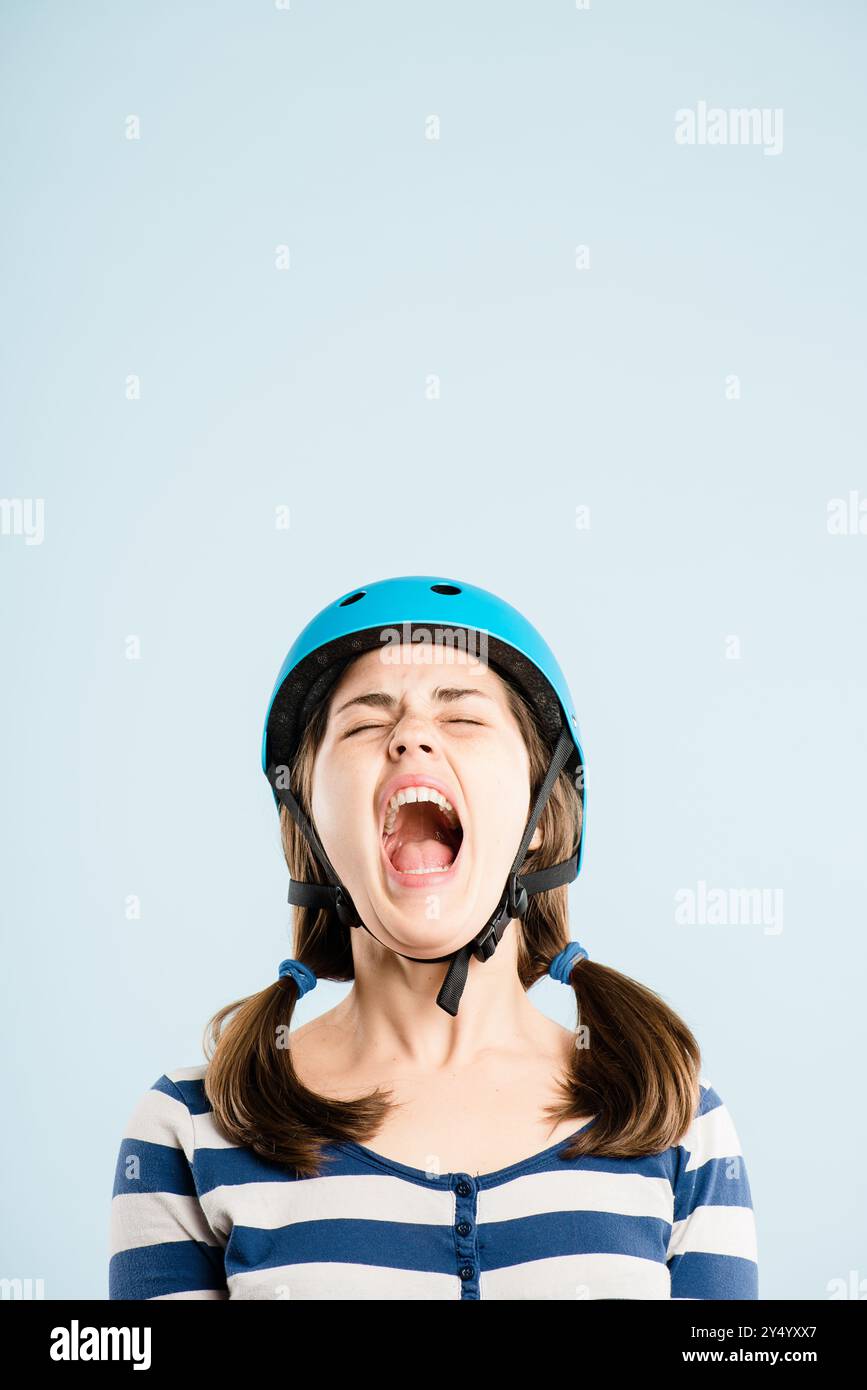 Cycling, helmet and woman with scream in studio space with voice, noise ...