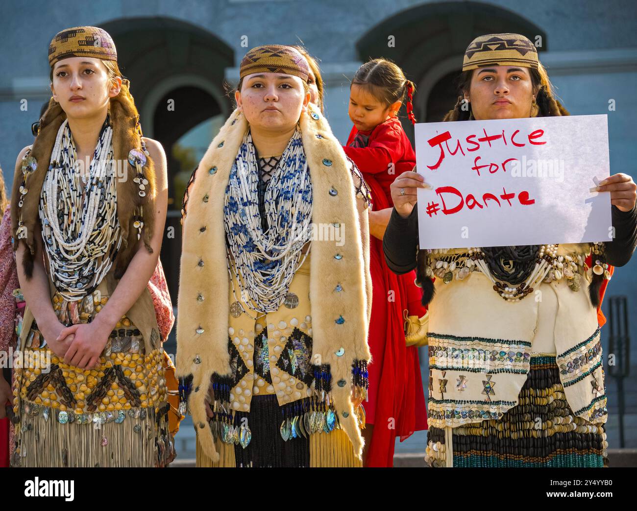 A female performer holds a sign with the name of a loved one at the Missing and Murdered ...