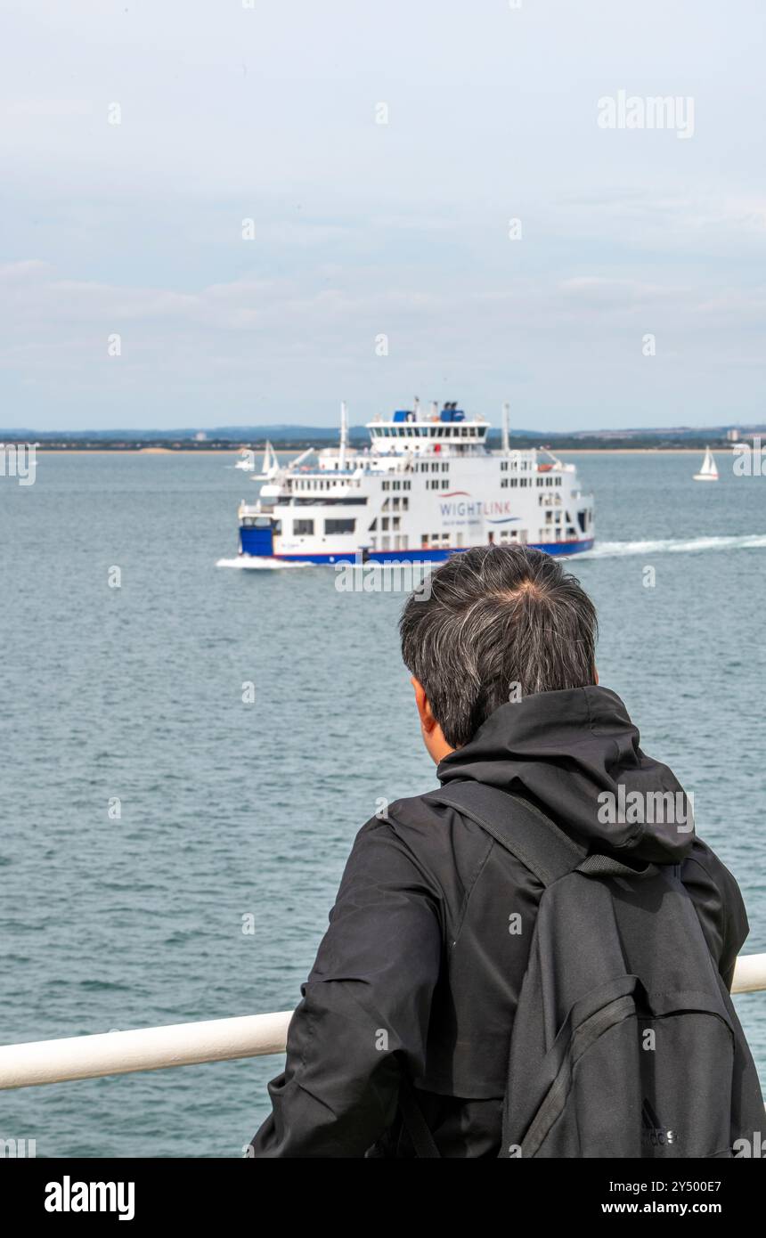 man standing alone on the isle of wight ferry, male watching passing ...