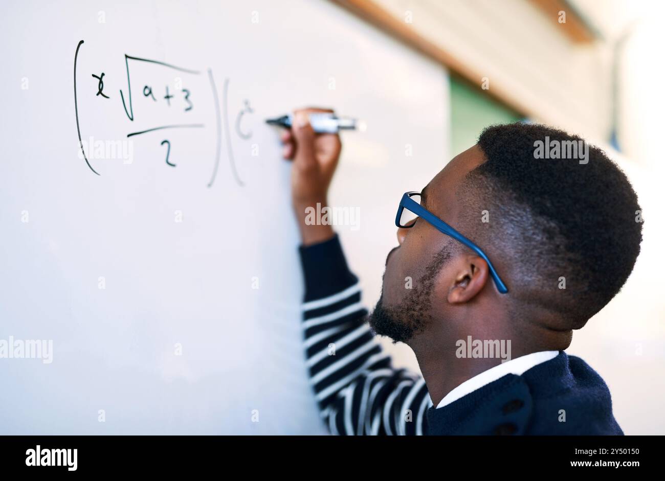 Teaching, classroom and black man writing on whiteboard for math lesson ...
