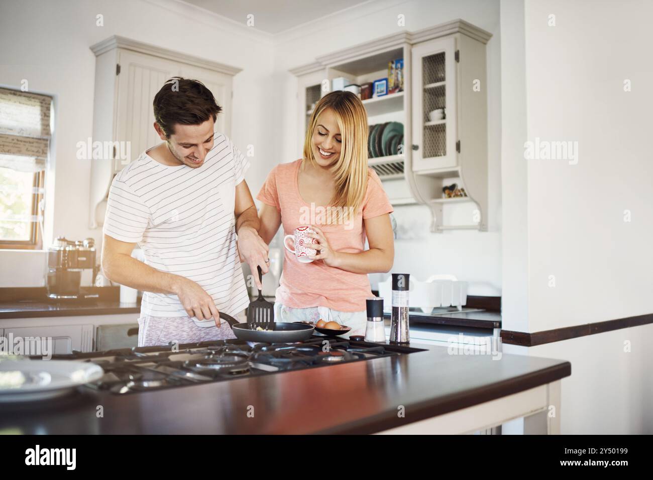 Couple, cooking and morning for breakfast in home, frying food and ...