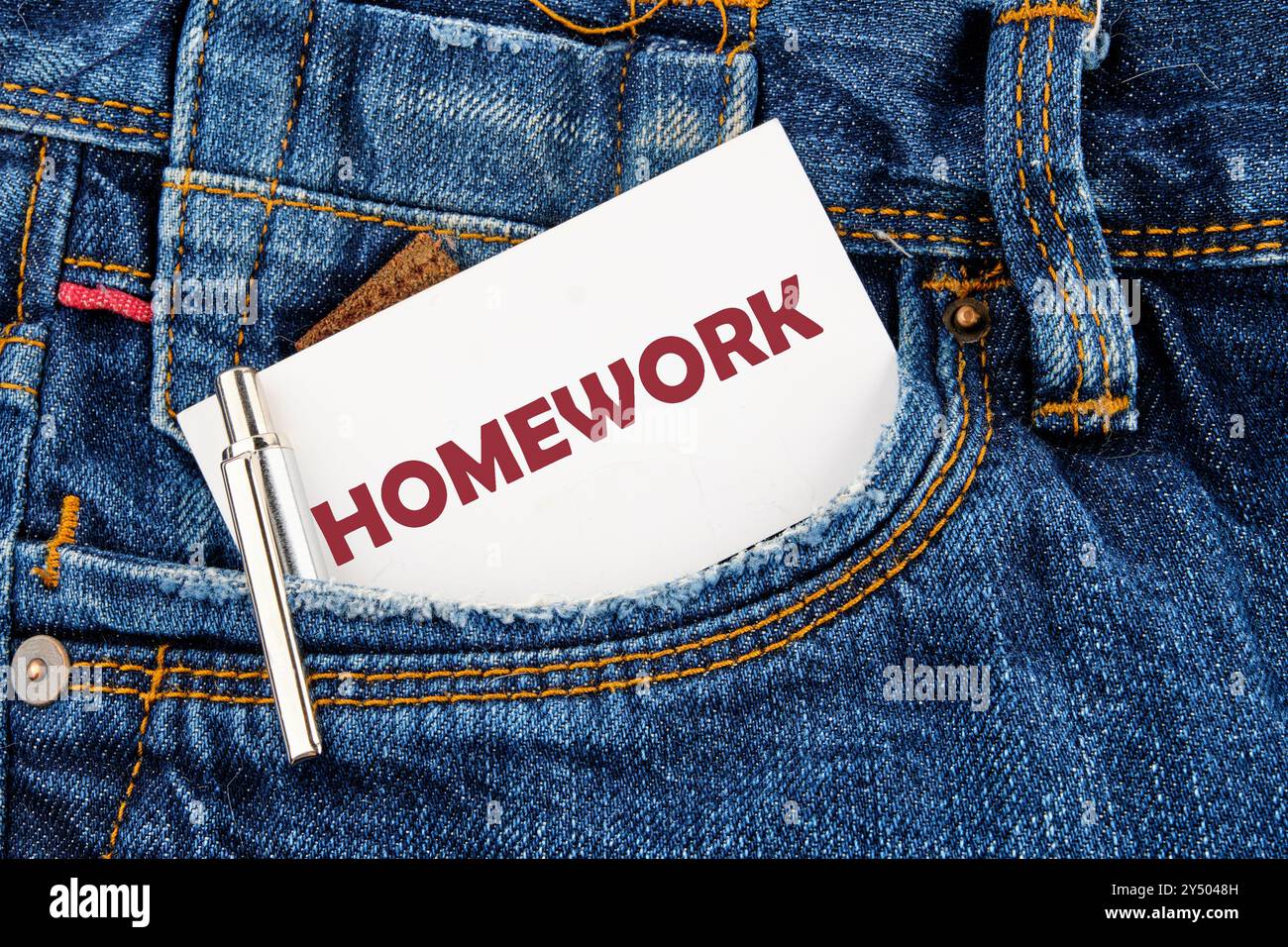 Word HOMEWORK on white card that appeared from the pocket of his jeans Stock Photo - Alamy