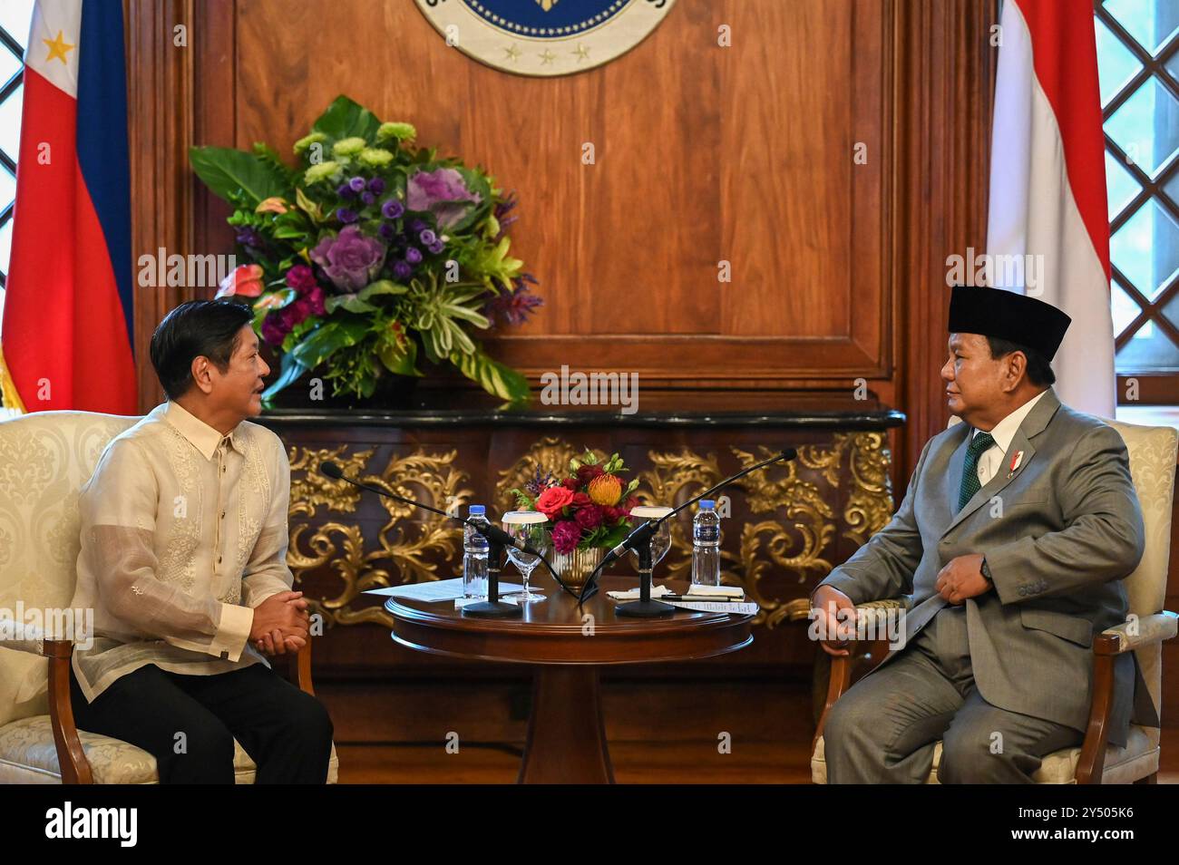 Philippine President Ferdinand Marcos Jr., left, speaks with Defense ...