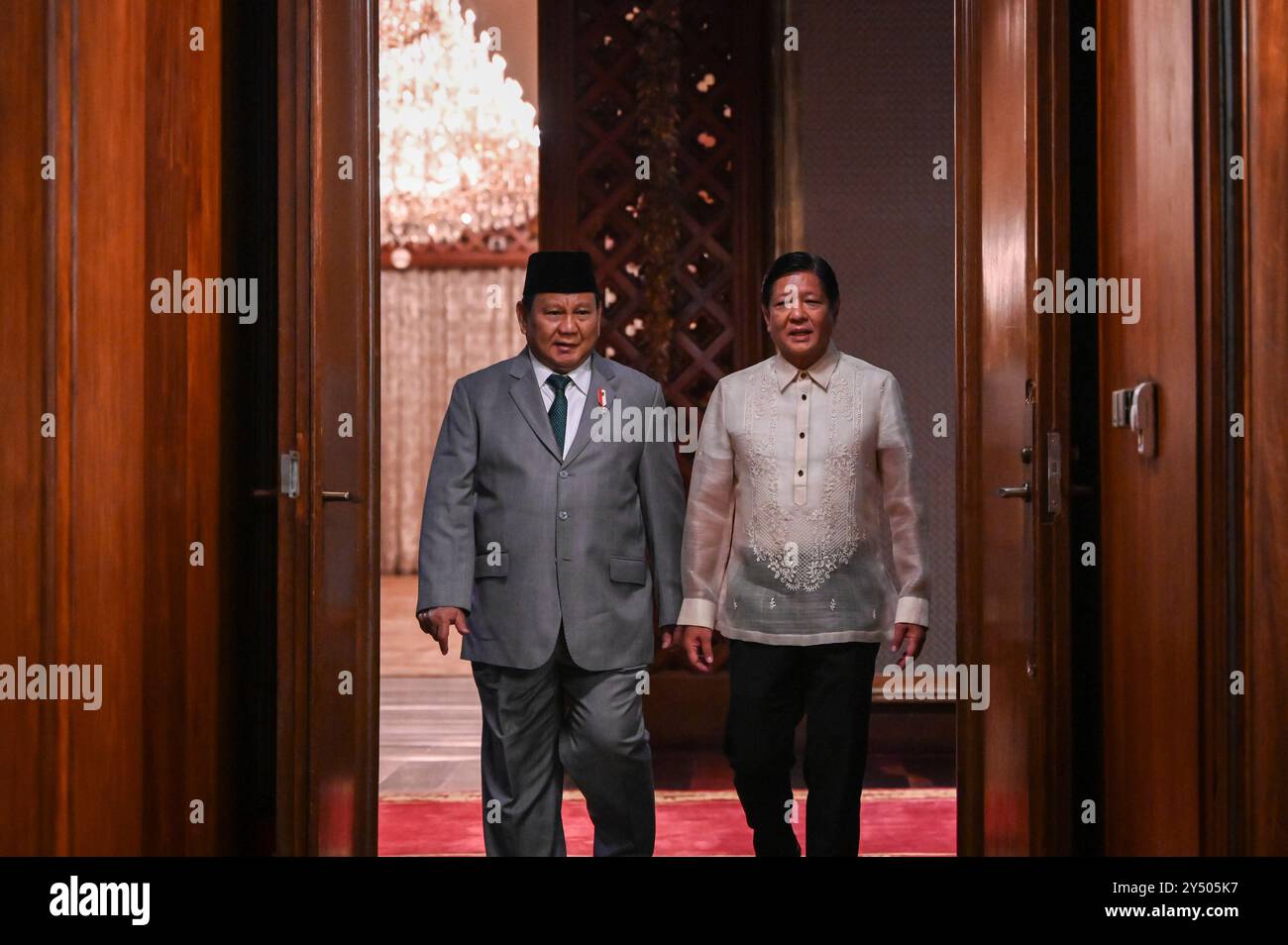 Philippine President Ferdinand Marcos Jr., right, walks with Defense ...