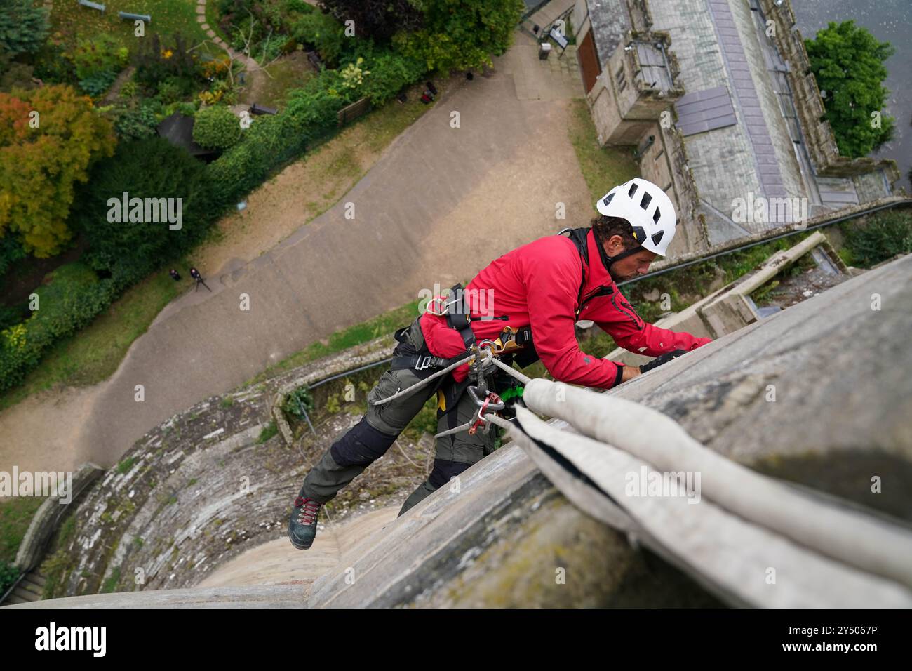 Building restoration specialists abseil down the walls of Warwick Castle's south front, known as ...