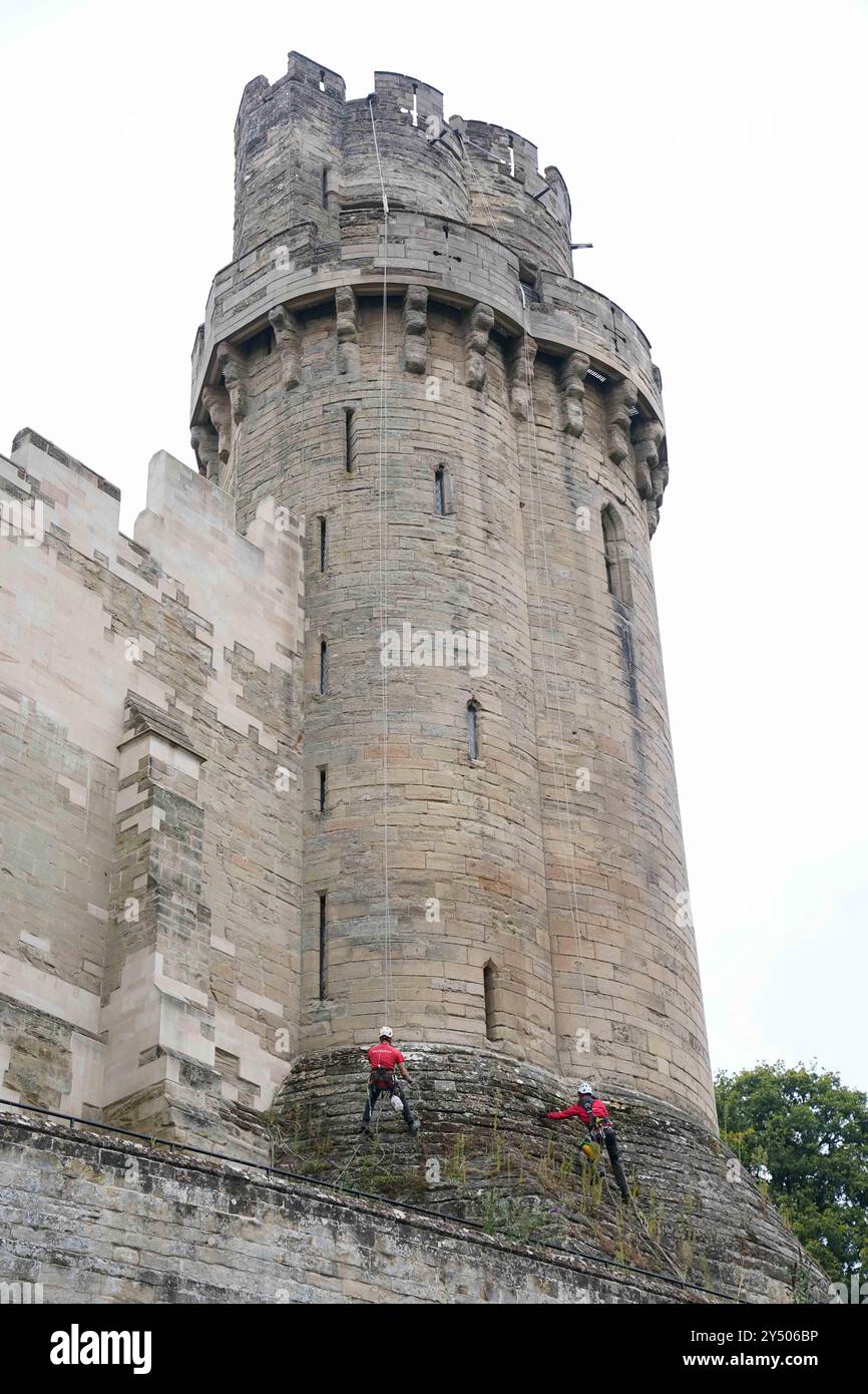 Building restoration specialists abseil down the walls of Warwick ...