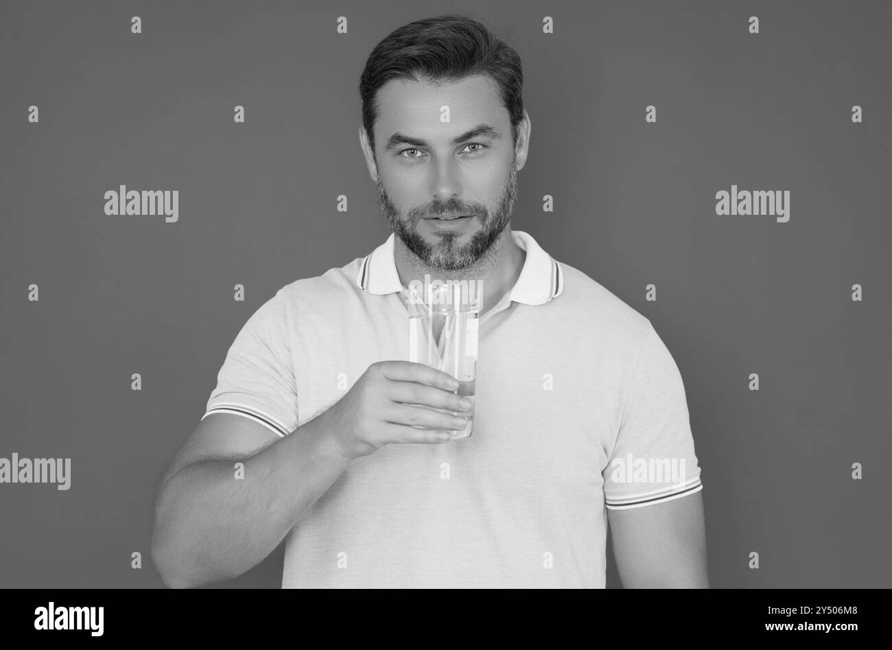 Guy drinking water isolated on studio background. Man enjoy pure ...