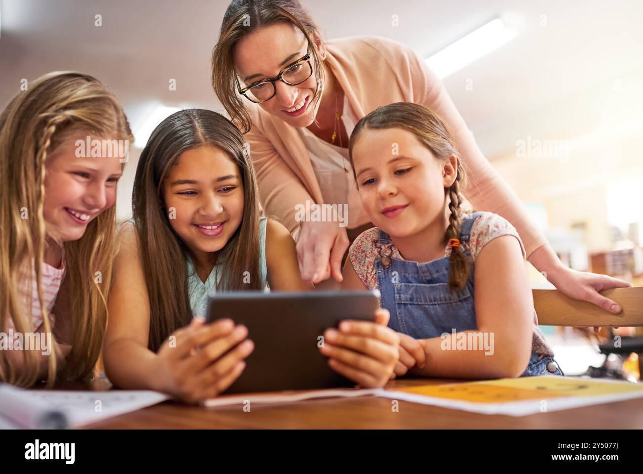 Teacher, children and support with tablet for education, elearning and ...