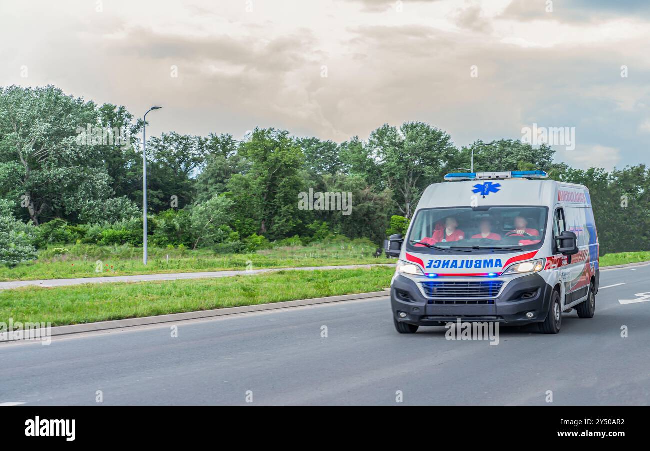 An ambulance with flashing lights, carrying paramedics on an urgent ...
