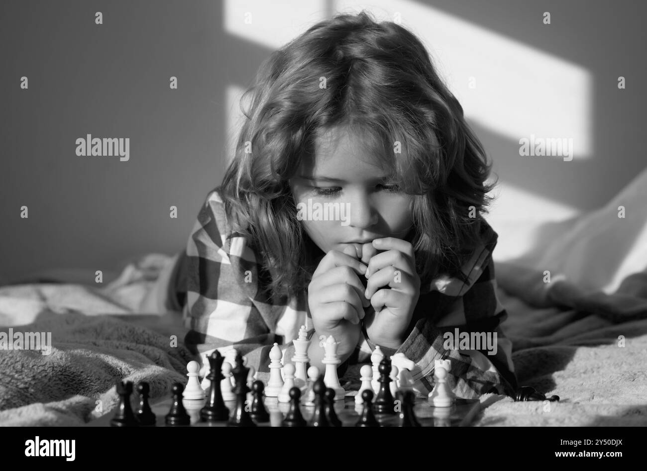 Clever thinking child. Little kid play chess. Thinking child. Chess ...