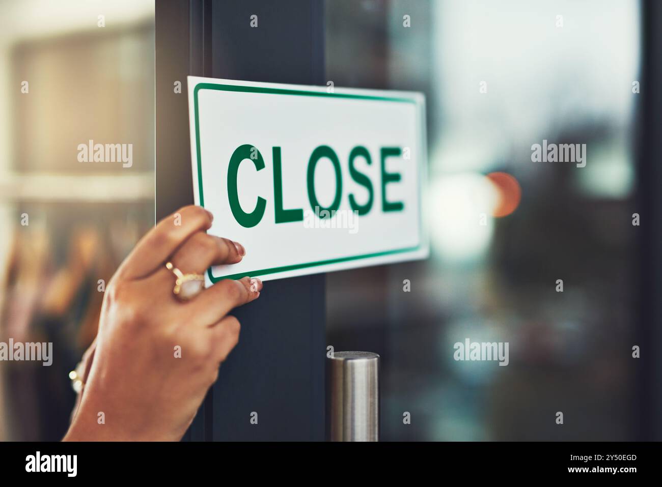 Door, hand and person with closed sign for small business, retail store ...