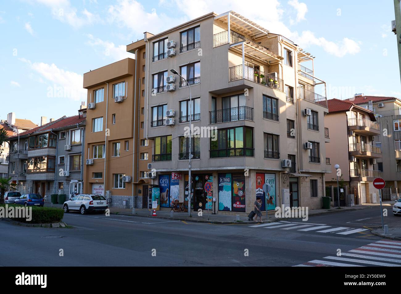 Modern residential architecture in a bustling neighborhood with shops ...