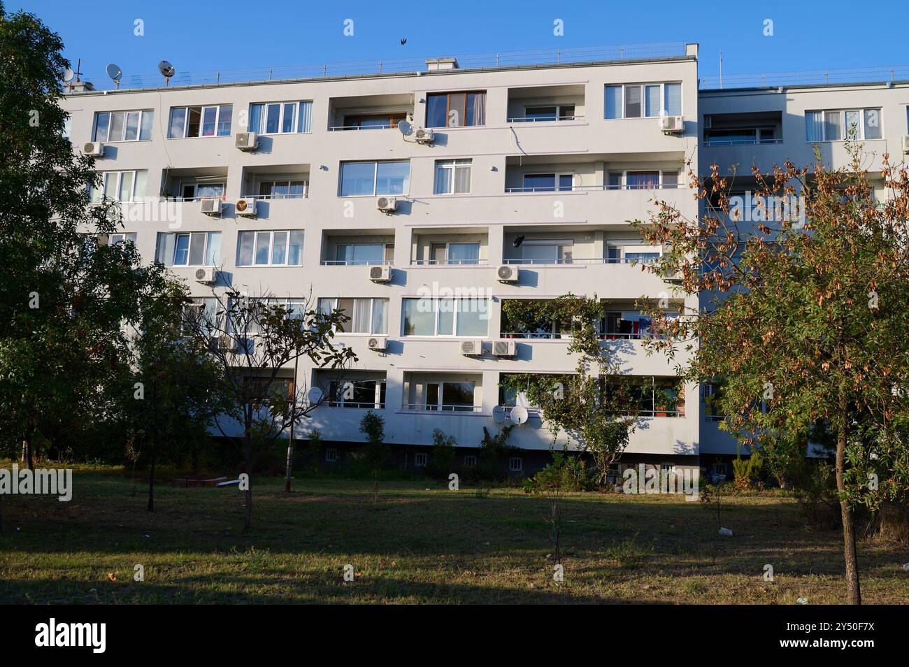 Modern apartment building with air conditioning units in a suburban ...