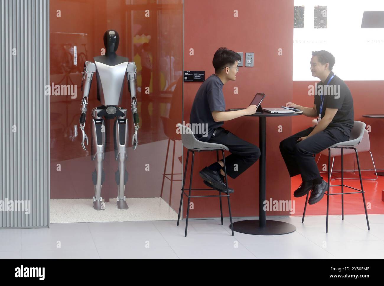 SHANGHAI, CHINA - AUGUST 9, 2024 - Electric cars and humanoid AI robots ...