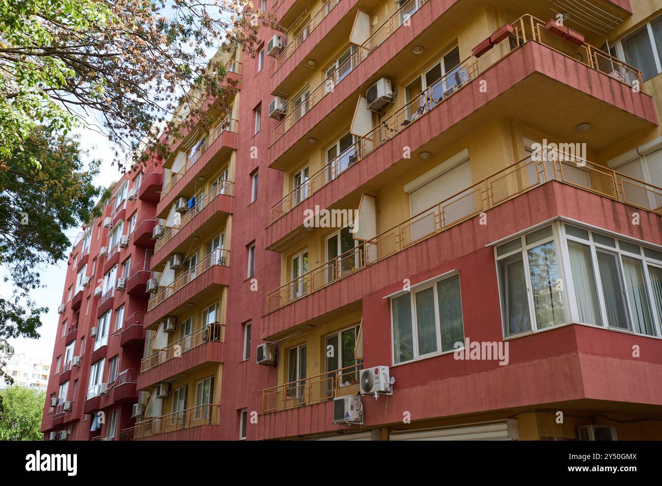 Red apartment building featuring a unique architectural style in a ...