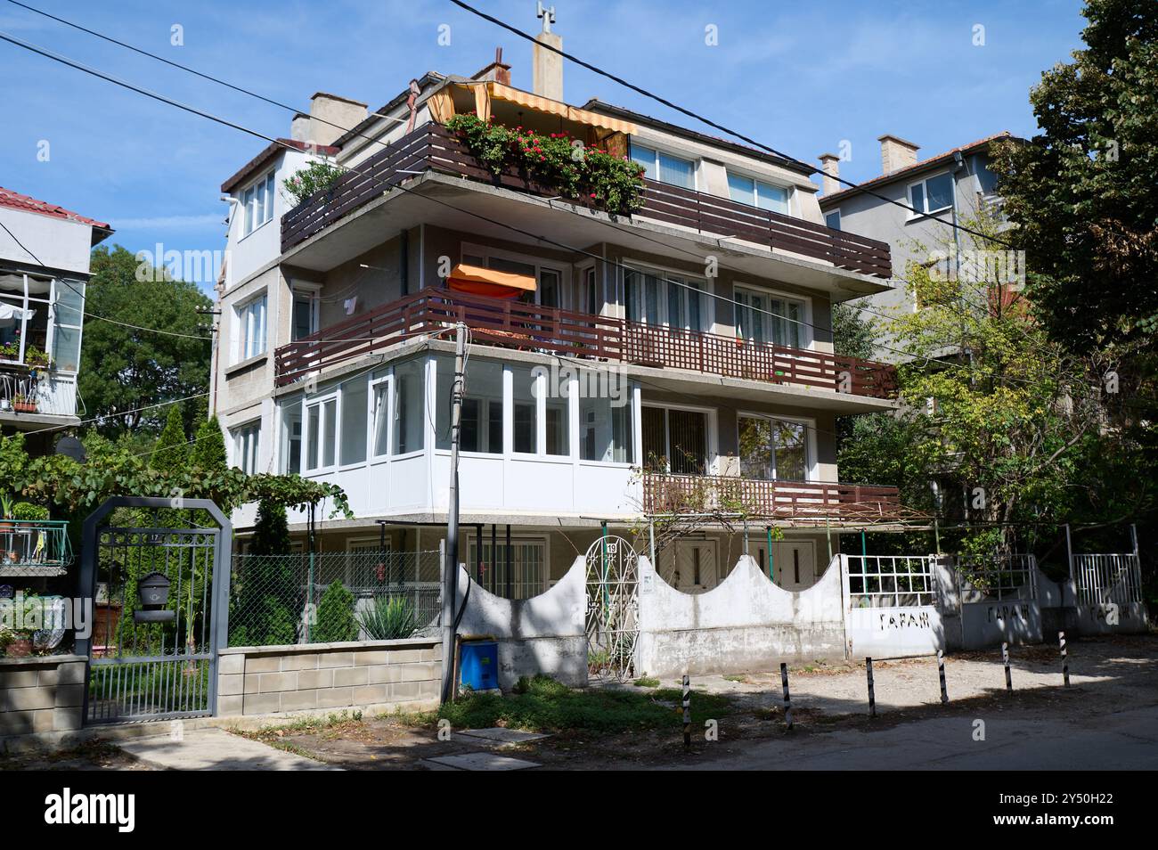 Modern three-story residential building featuring balconies and ...